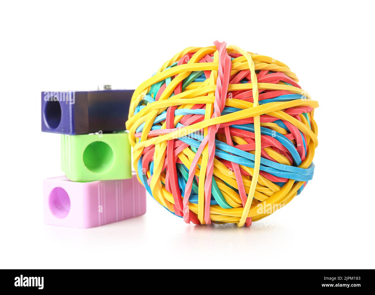 Colorful rubber band ball and sharpeners on white background Stock ...
