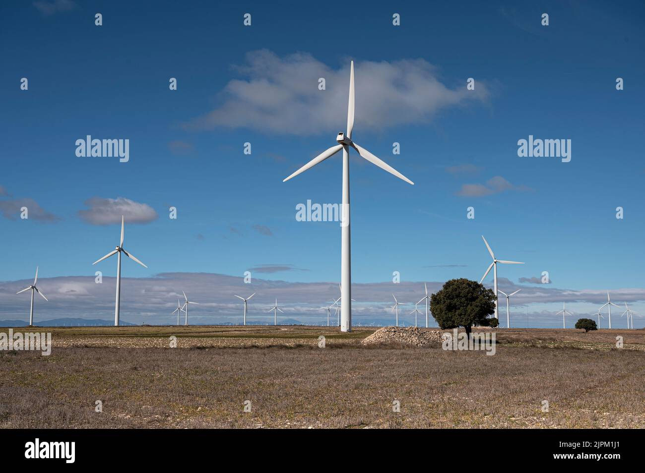 The wind turbines in wind farm under blue sky Stock Photo - Alamy