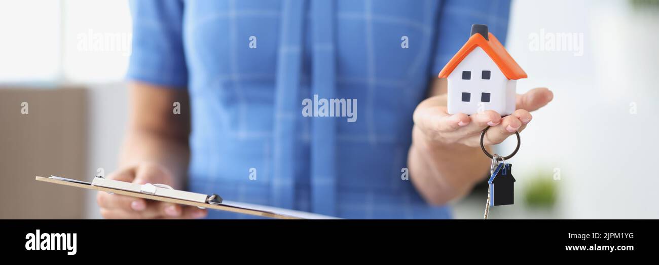Insurance agent or realtor is holding house and keys Stock Photo - Alamy