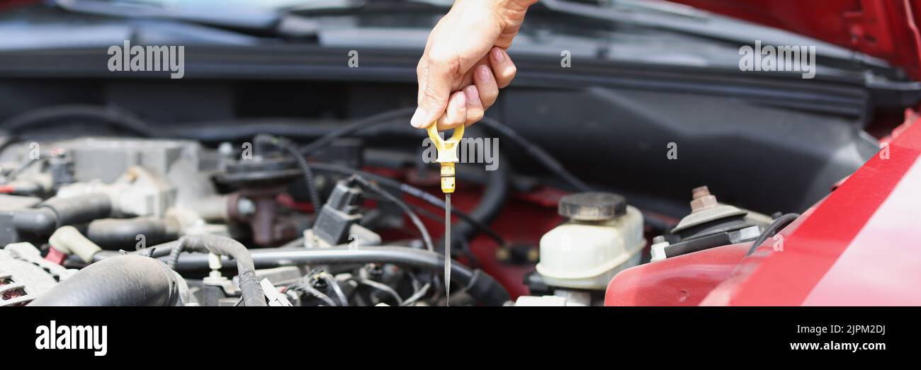 Dipstick for checking oil level in car engine closeup Stock Photo - Alamy