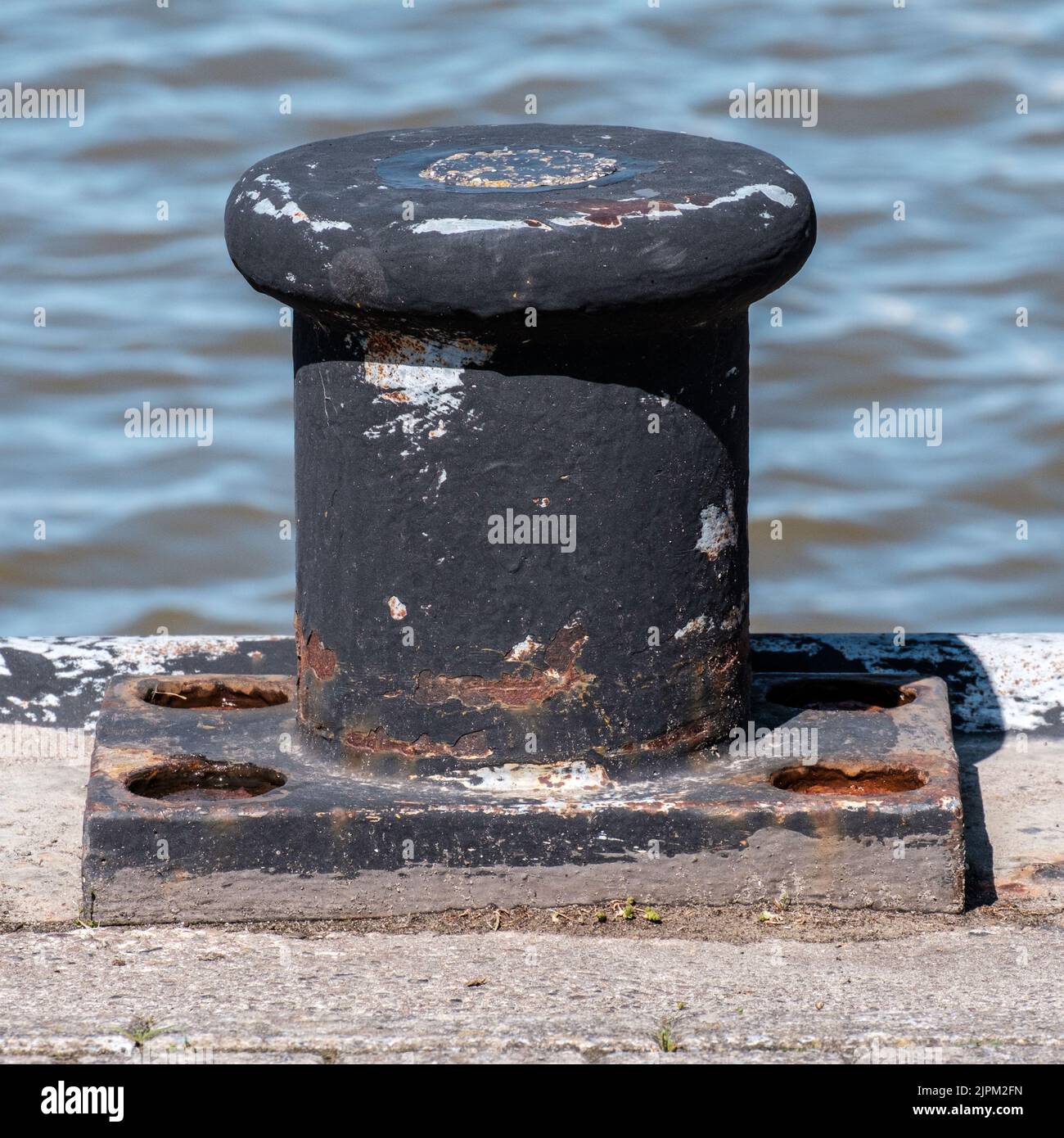 A closeup of an old rusty metallic mooring bollard on a pier Stock ...