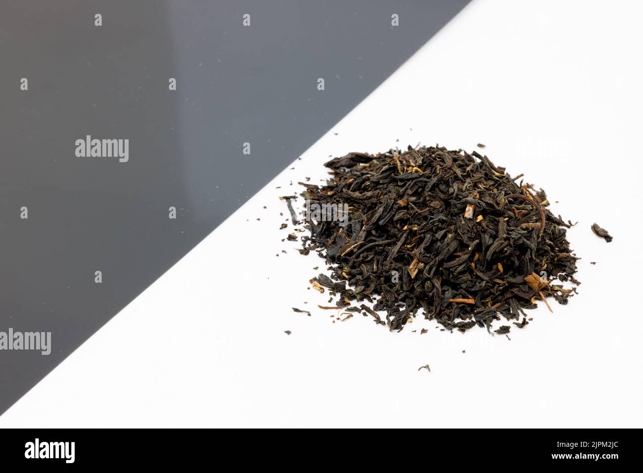 The dried black tea leaves on a white surface Stock Photo - Alamy