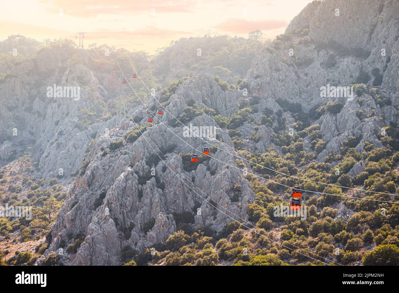 Cable car carries tourists in closed gondolas to a viewing platform ...