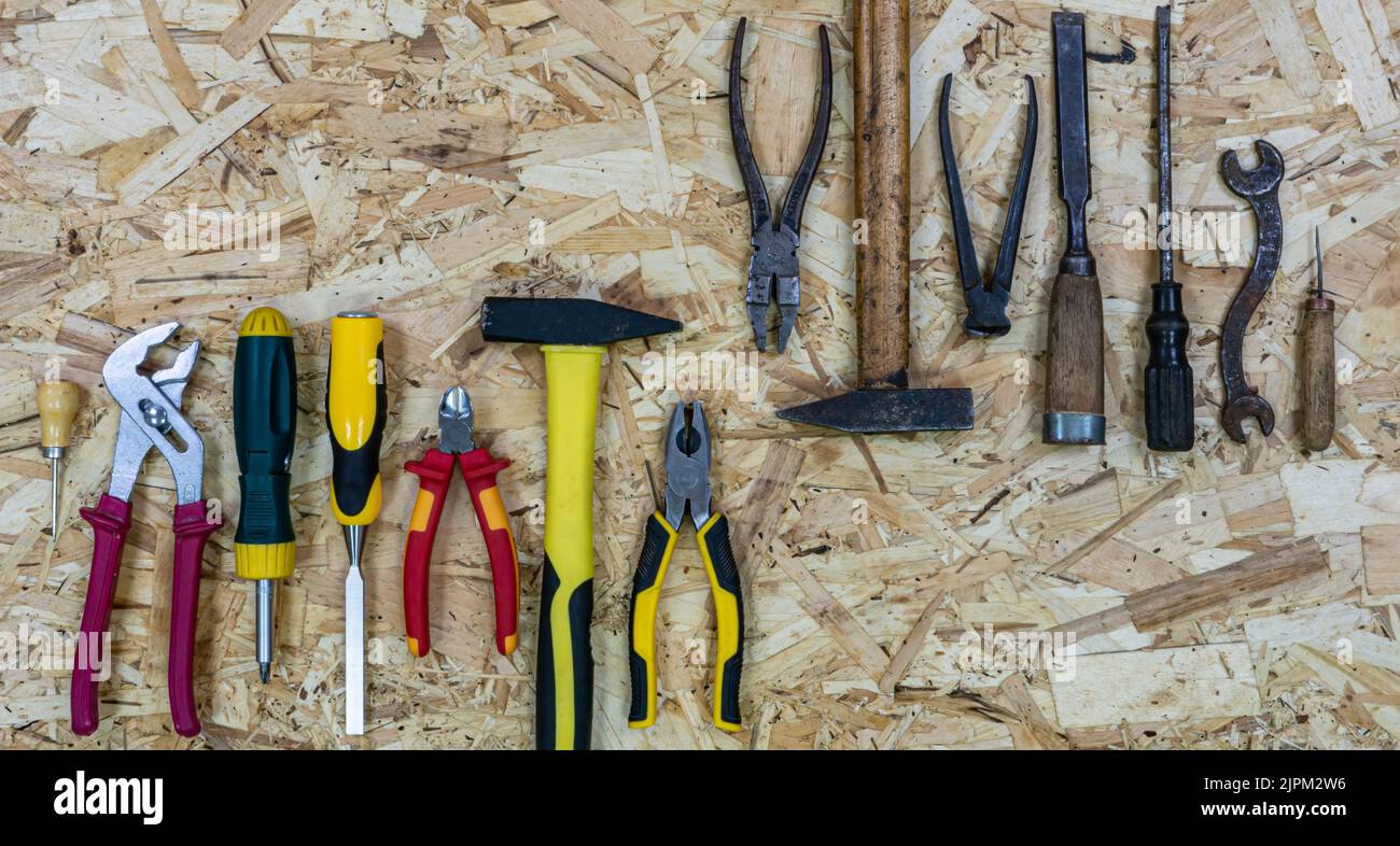 Old rusty tools versus modern tools on the OSB sheet. Concept ...