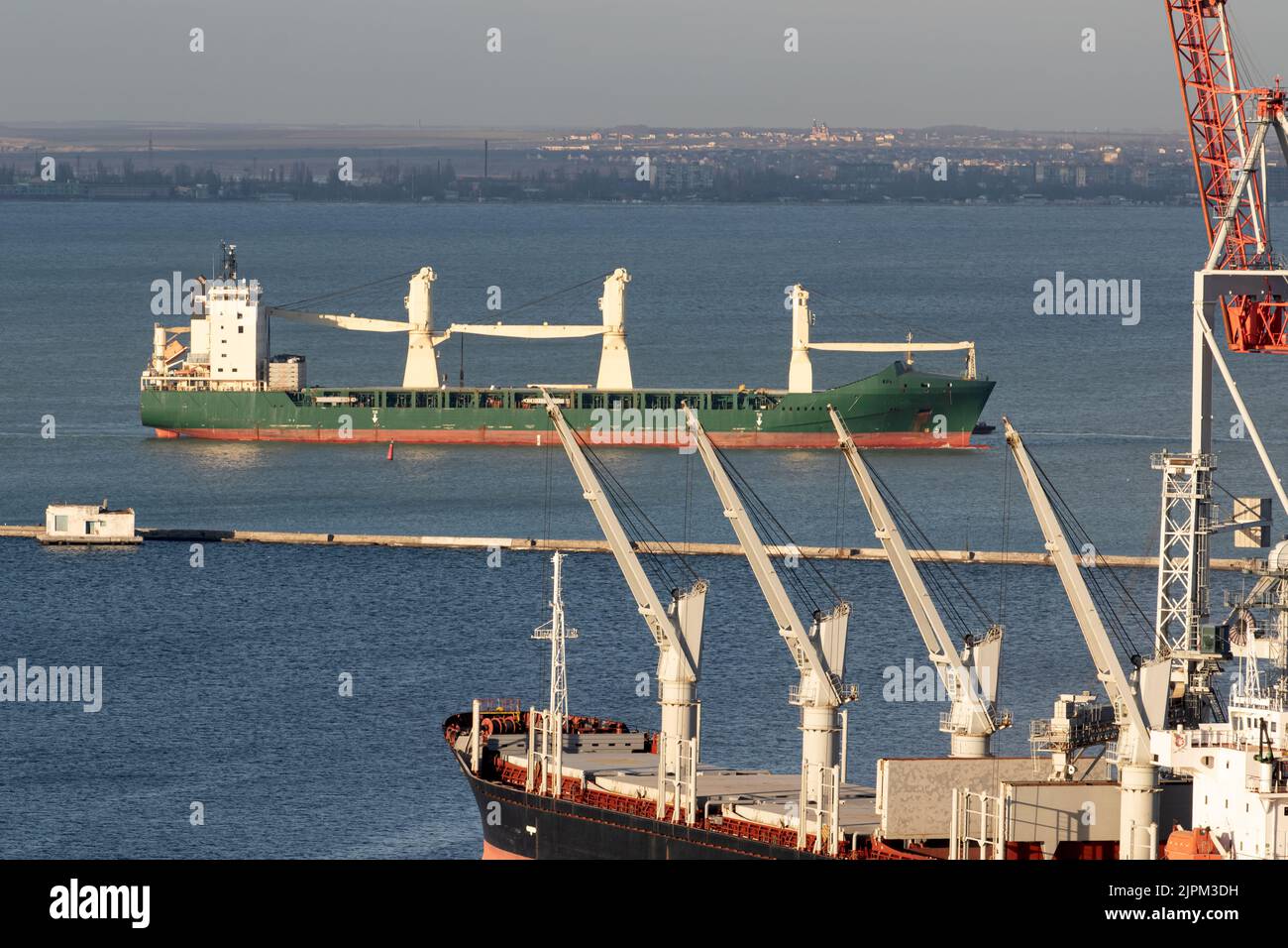 Commercial sea port in peacetime. Marine cranes, warehouses, tankers ...