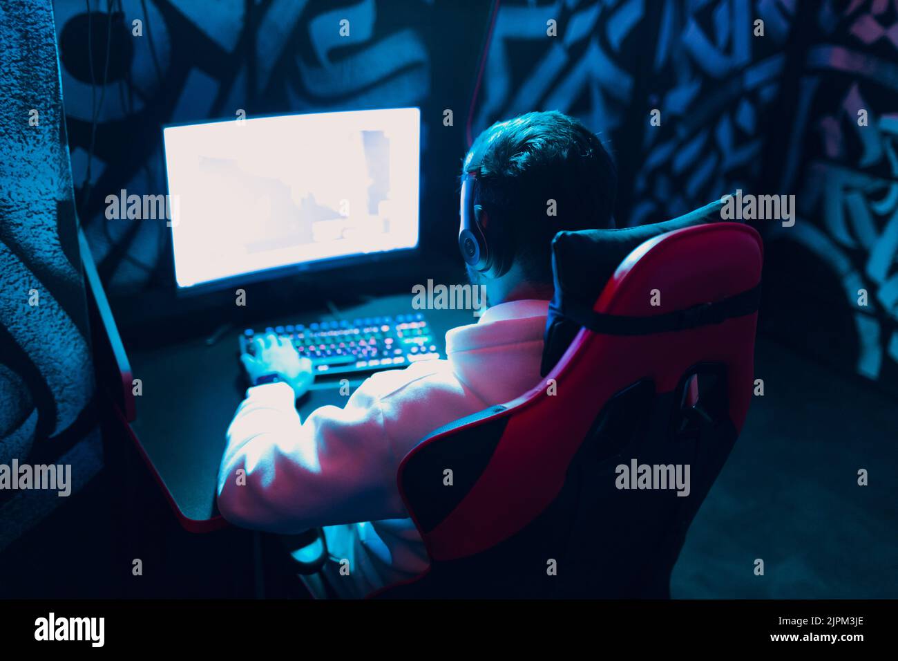 Guy playing gaming game on computer at game club Stock Photo - Alamy