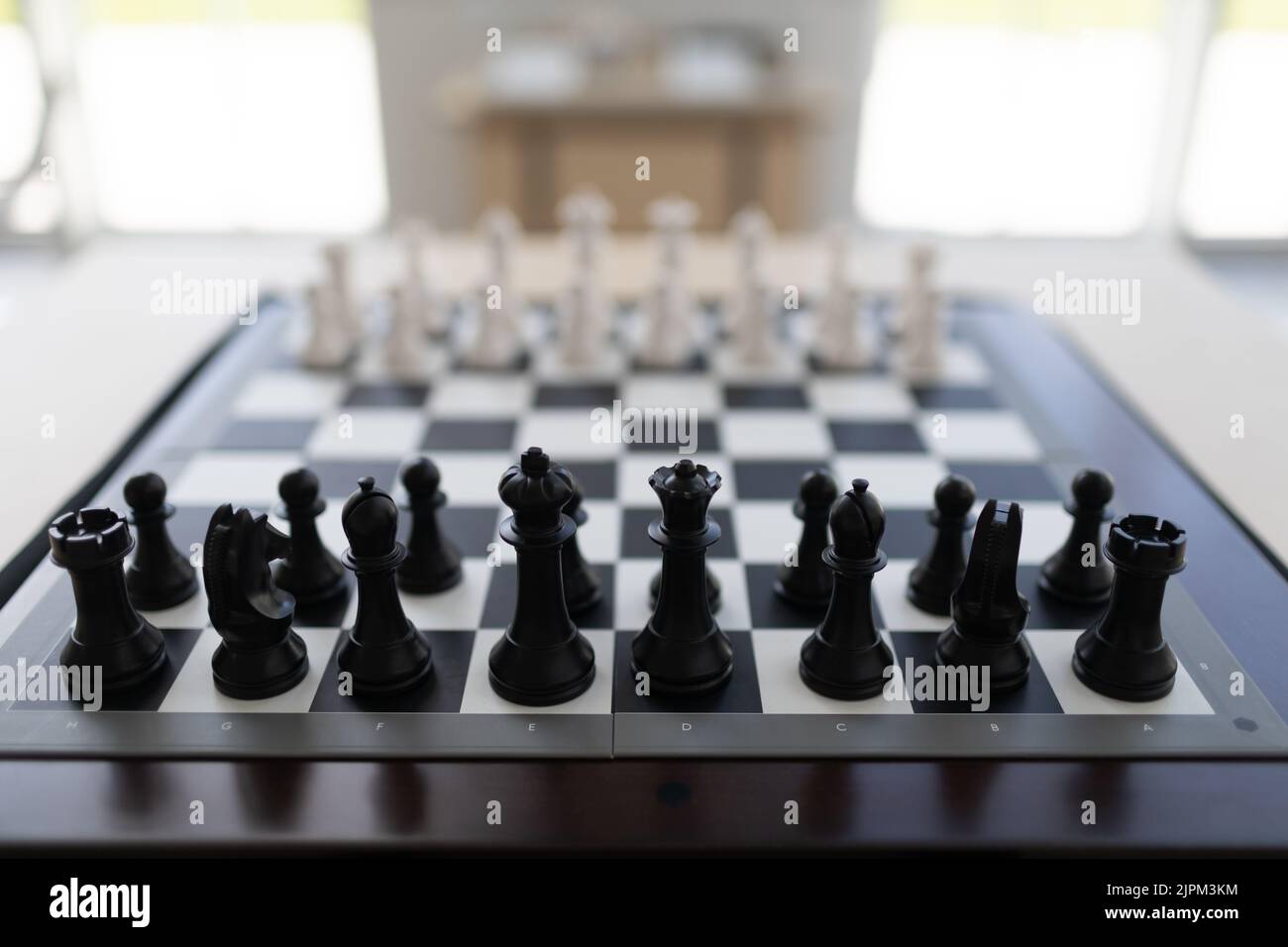 New chess board with chess pieces on table for game Stock Photo - Alamy