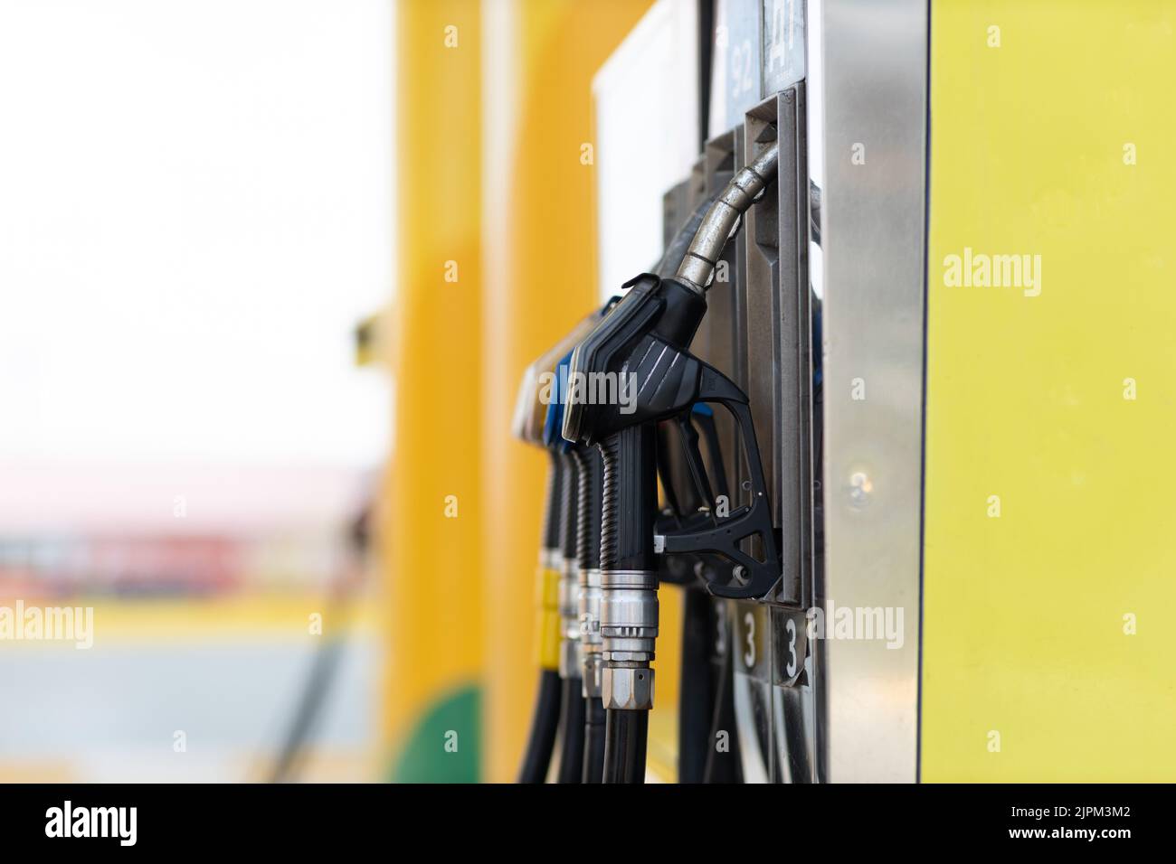 Close up filling gun in his hand at gas station Stock Photo - Alamy