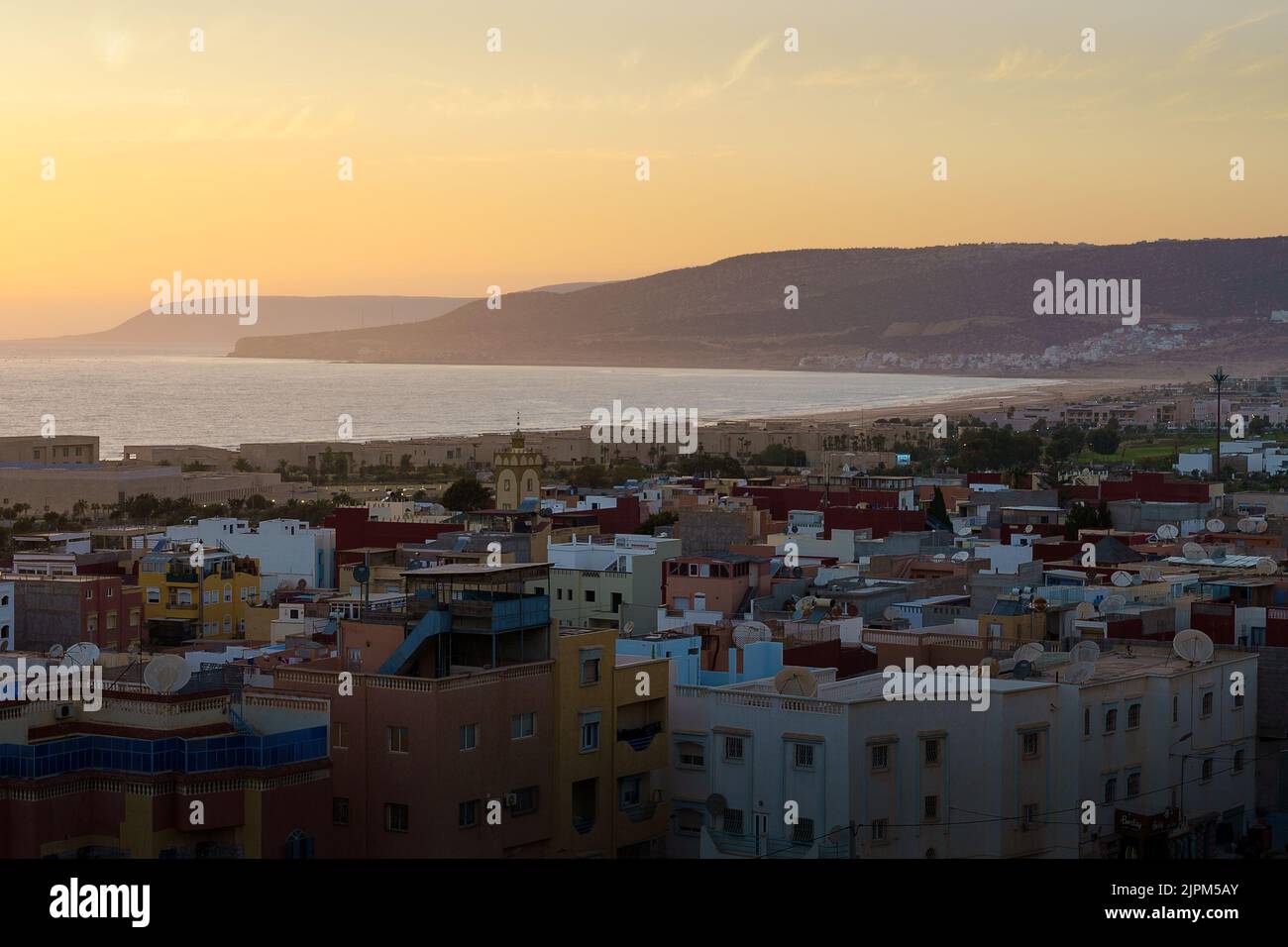 An aerial view of village Tamraght surrounded by buildings and water ...