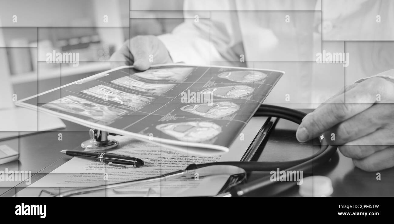 Doctor holding a mri scan at his desk, geometric pattern Stock Photo ...