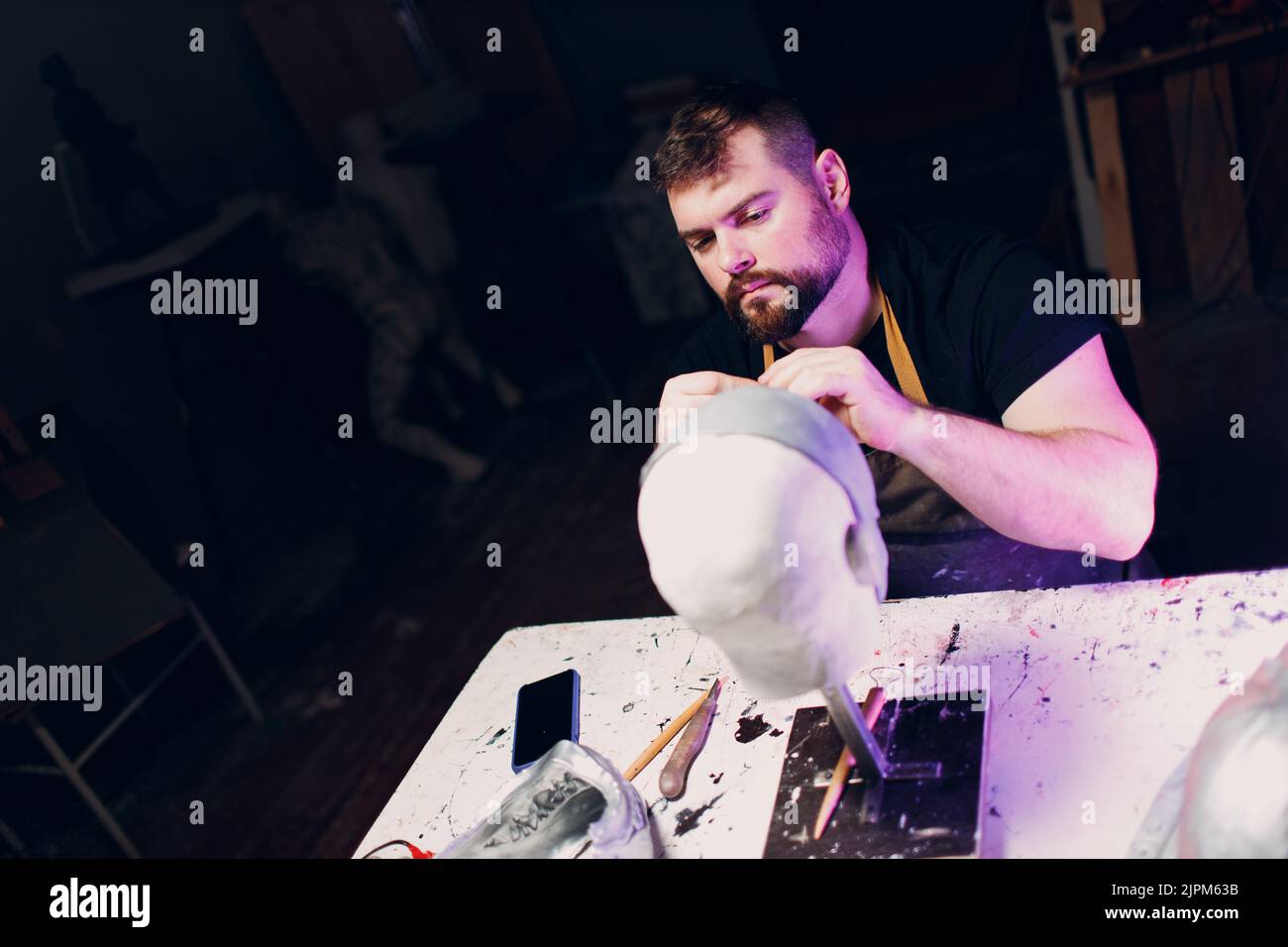 Artisan craftsman create mask based on plaster cast. Gypsum mold and ...