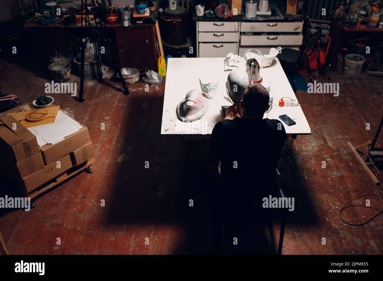 Artisan craftsman create mask based on plaster cast. Gypsum mold and ...