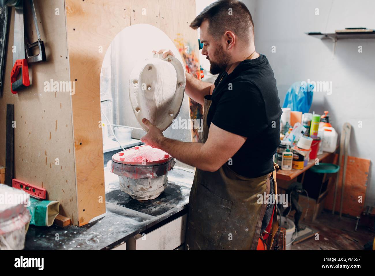 Artisan craftsman create mask based on plaster cast. Gypsum mold and ...