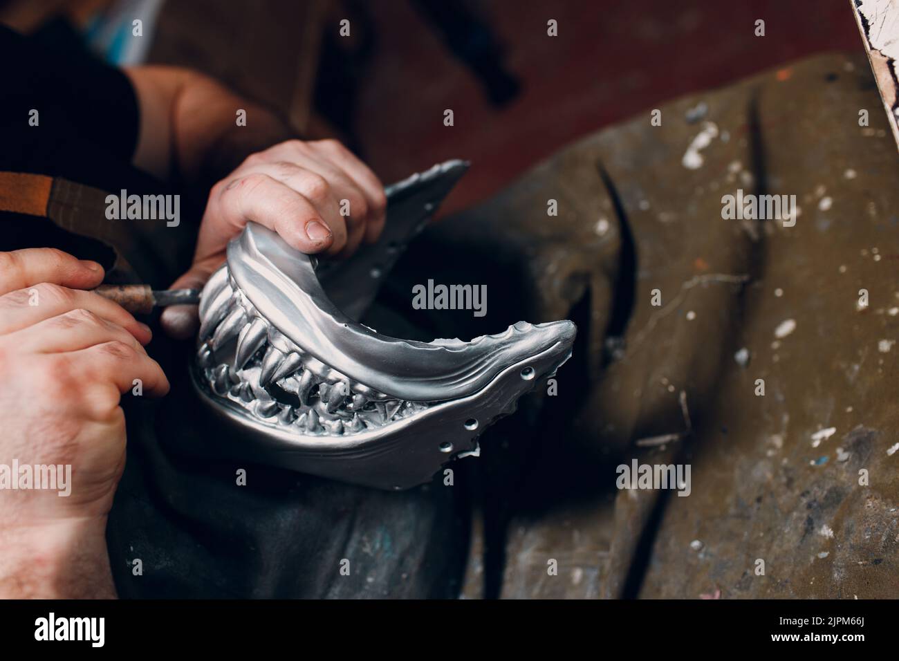 Artisan craftsman create mask based on plaster cast. Gypsum mold and ...