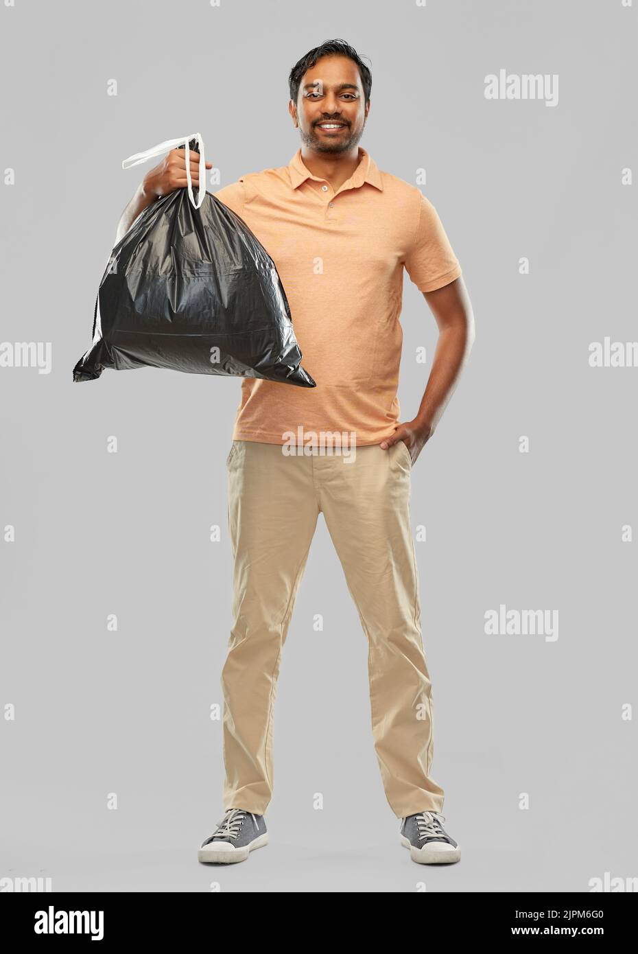 smiling indian man holding trash bag Stock Photo - Alamy
