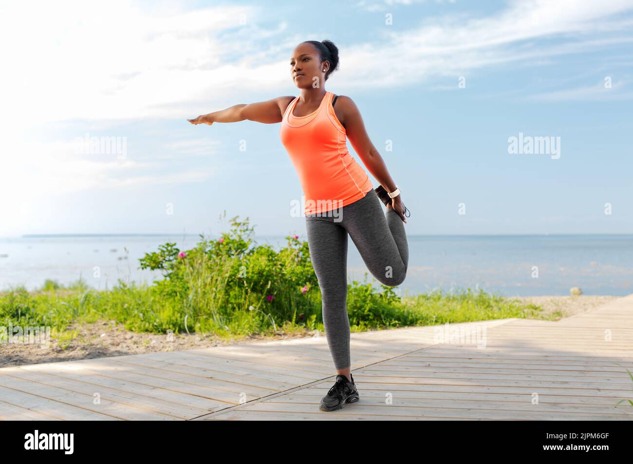 young african american woman exercising on beach Stock Photo - Alamy