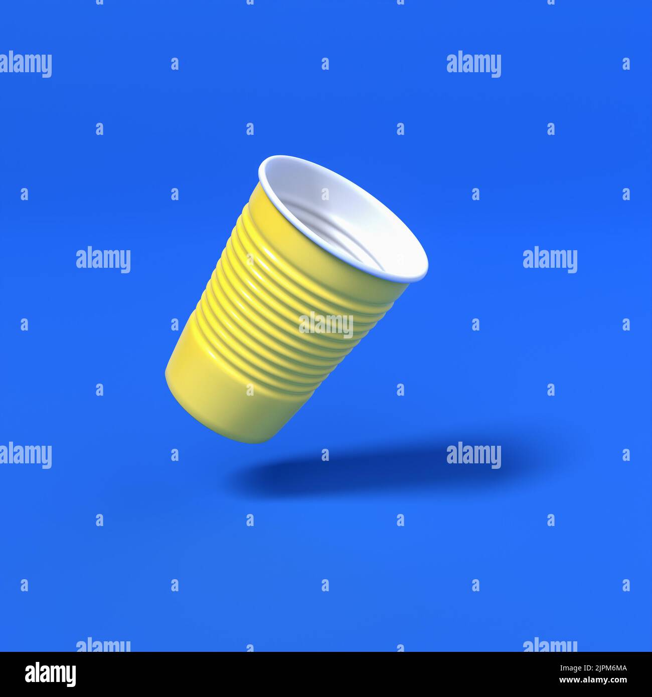 A yellow and white plastic cup hovering over a blue background. Concept ...