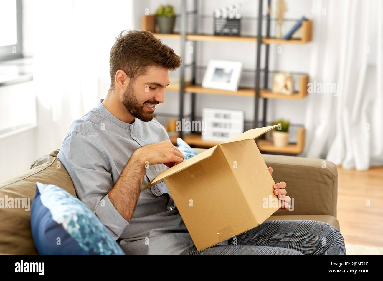 Happy person opening package hi-res stock photography and images - Alamy