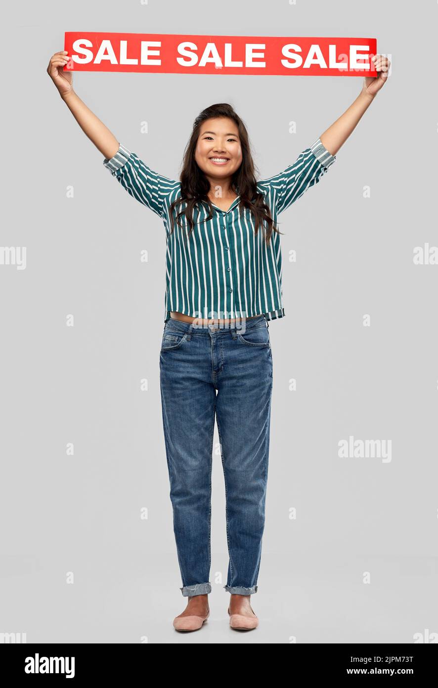 happy smiling young asian woman with sale banner Stock Photo - Alamy