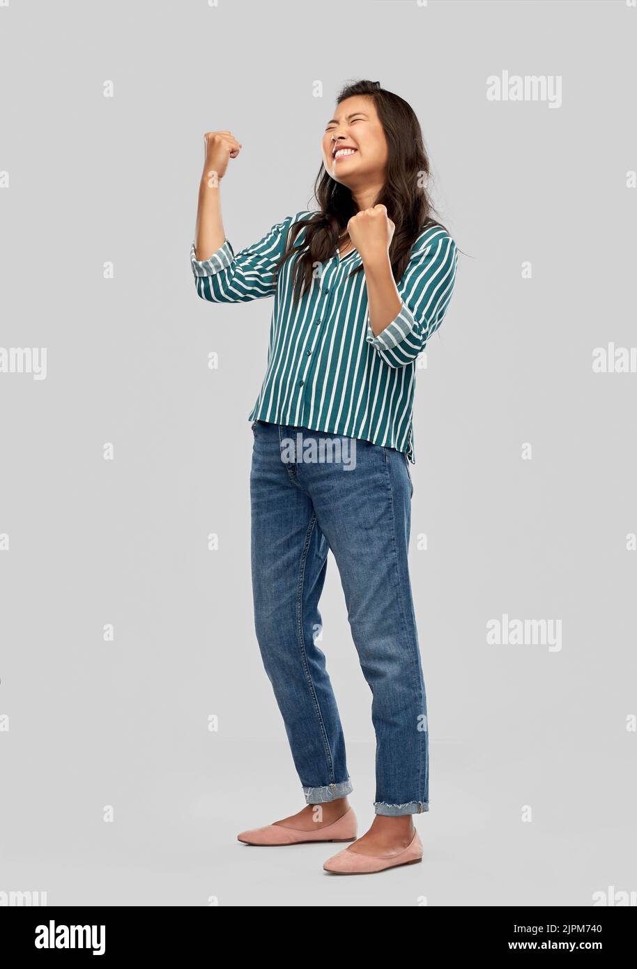 happy young asian woman celebrating success Stock Photo - Alamy