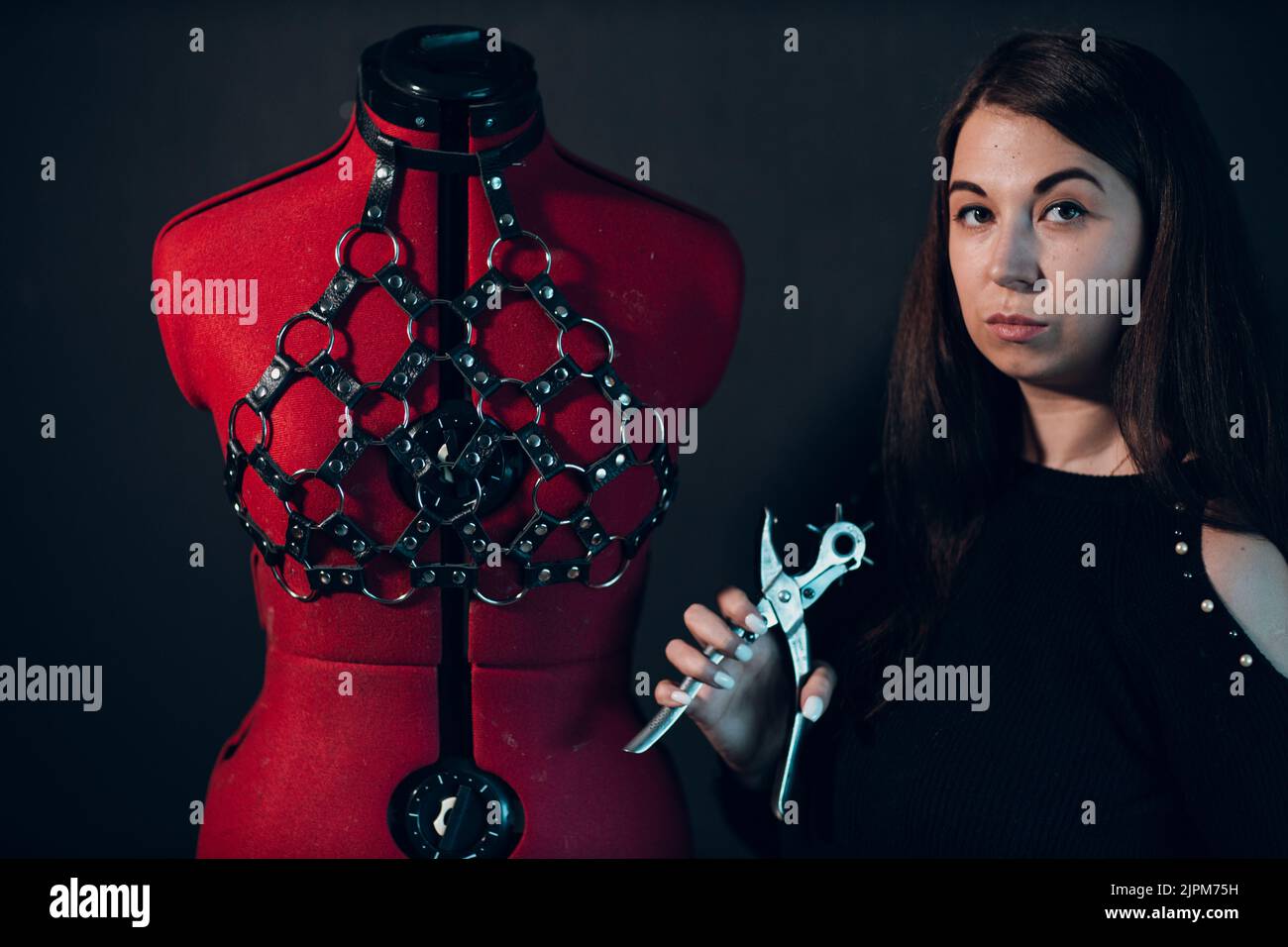 Tanner woman portrait with leather harness on mannequin Stock Photo - Alamy