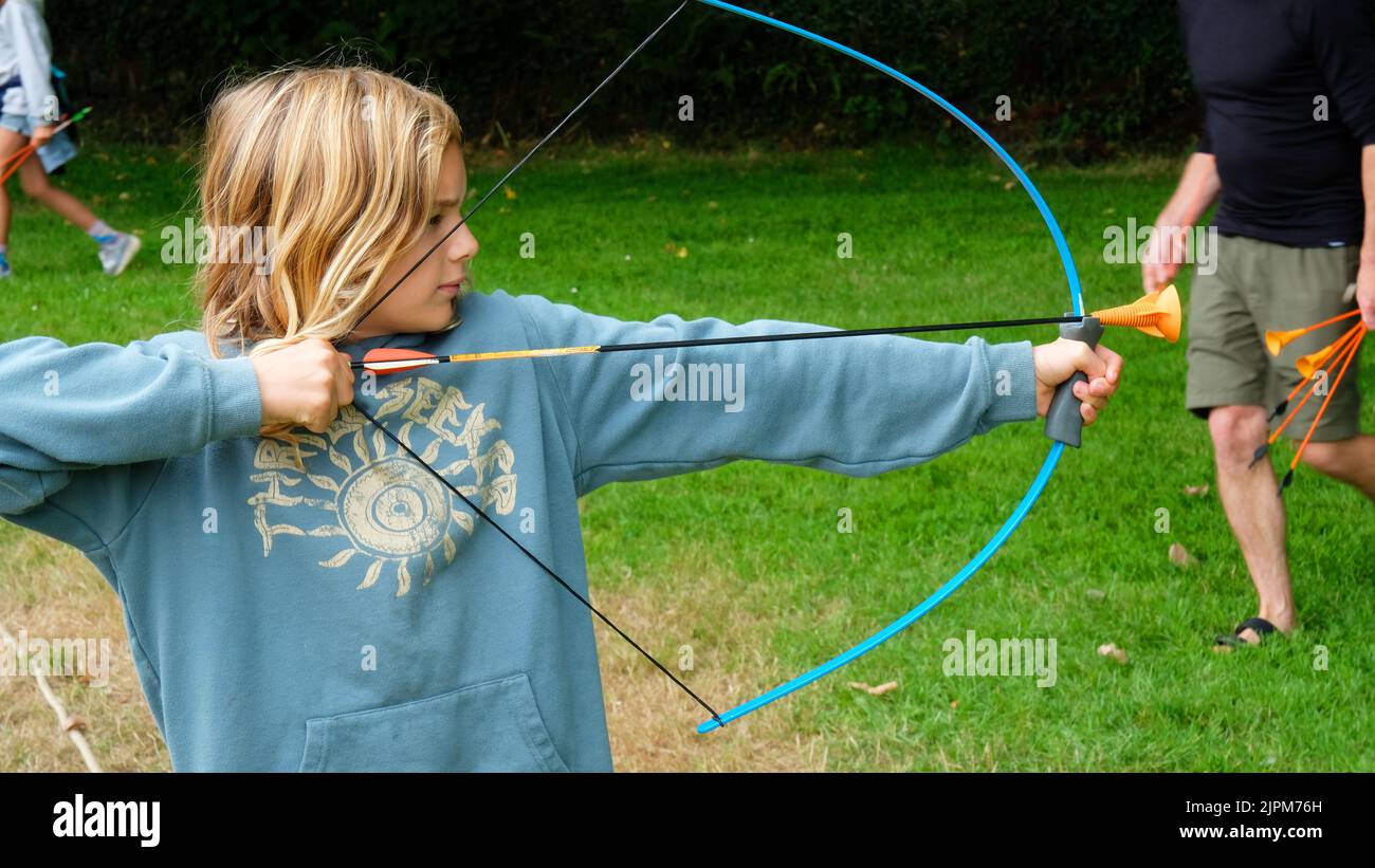 Young boy playing beginners archery - John Gollop Stock Photo - Alamy