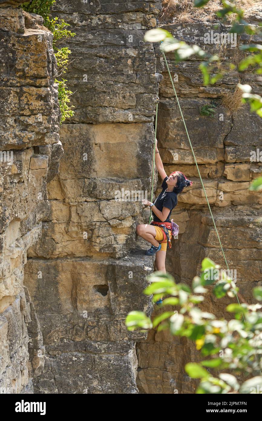 Teenage girl in a difficult rock climbing tour in the Rockgarden in Hessigheim, Neckar valley ...