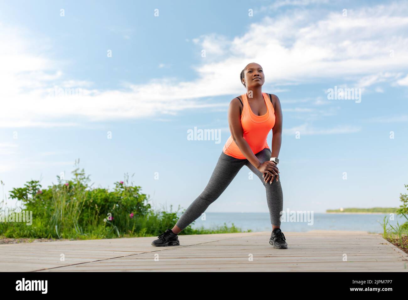Woman exercising sea stretching hi-res stock photography and images - Alamy
