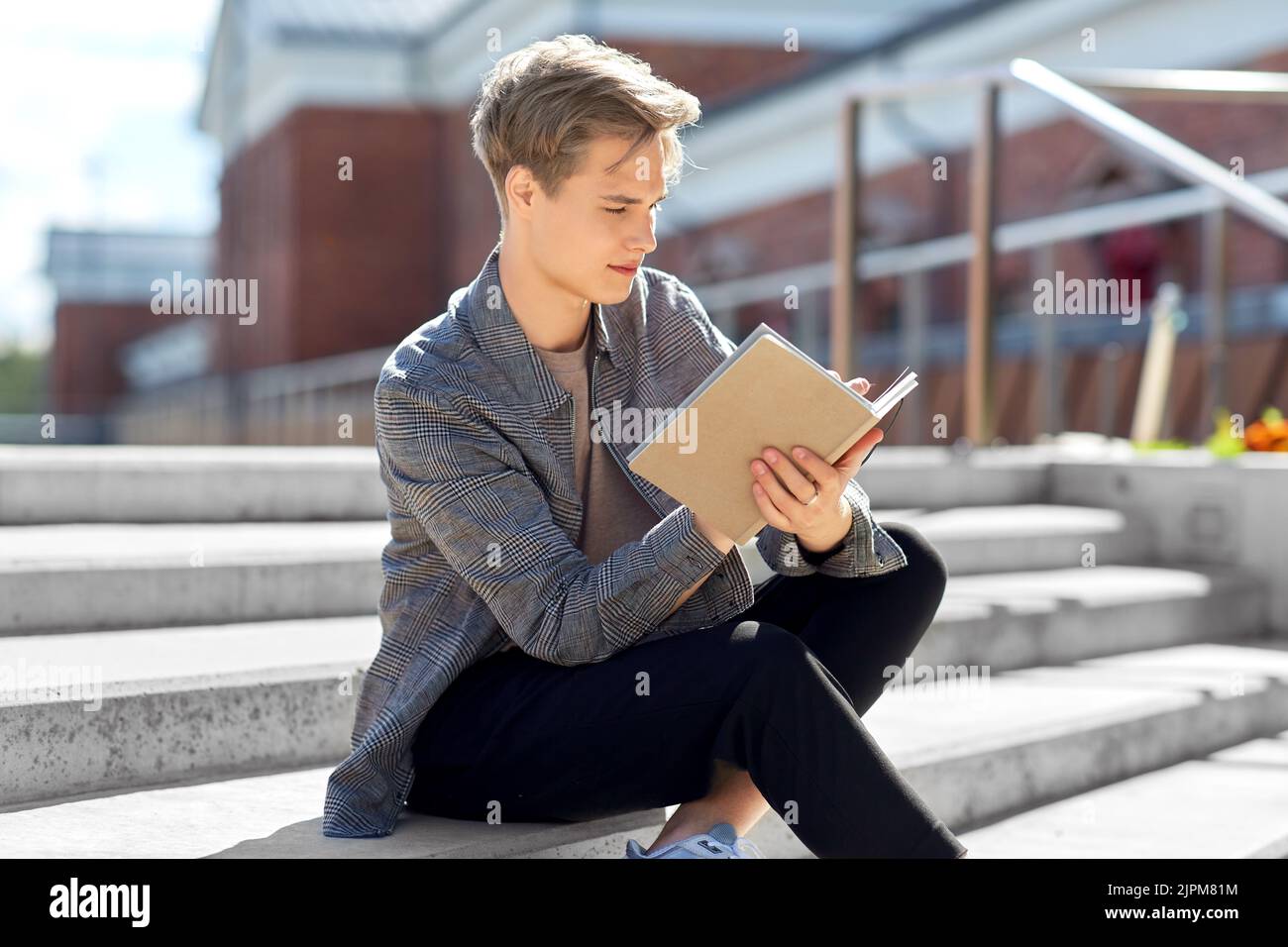 young man with notebook or sketchbook in city Stock Photo - Alamy