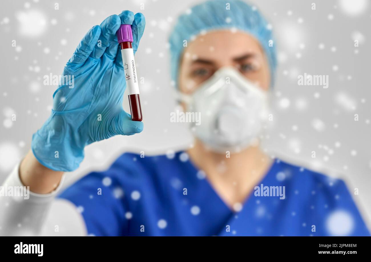 Doctor holding beaker coronavirus blood hi-res stock photography and ...