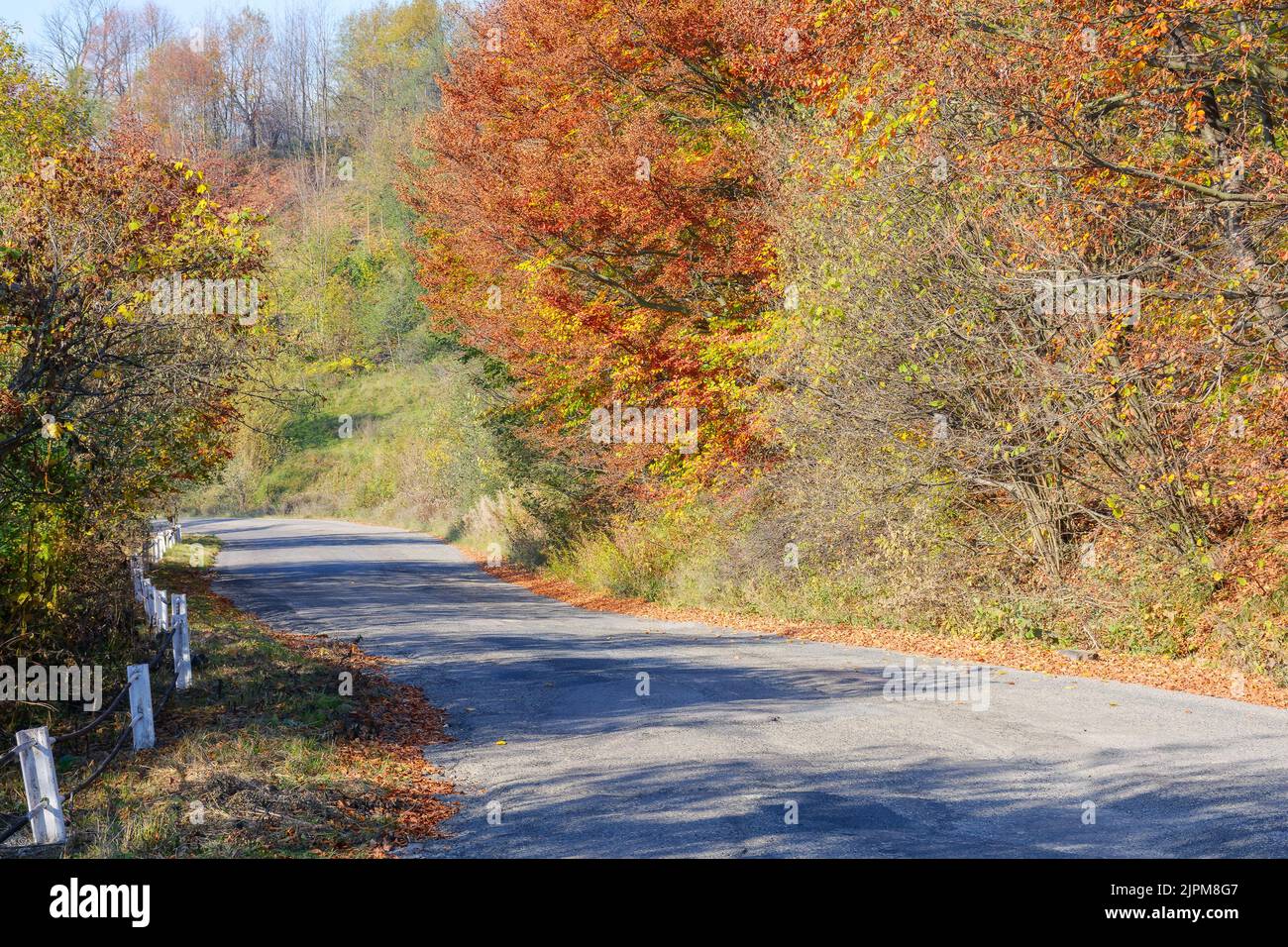 countryside road in autumn. mountainous scenery on a warm sunny day ...