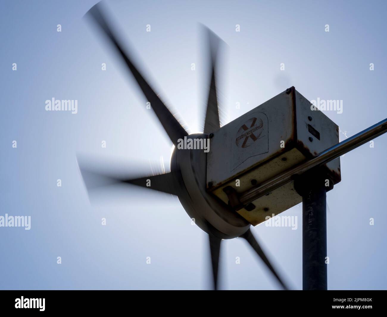 An illuminated road sign powered by a solar panel and wind turbine ...