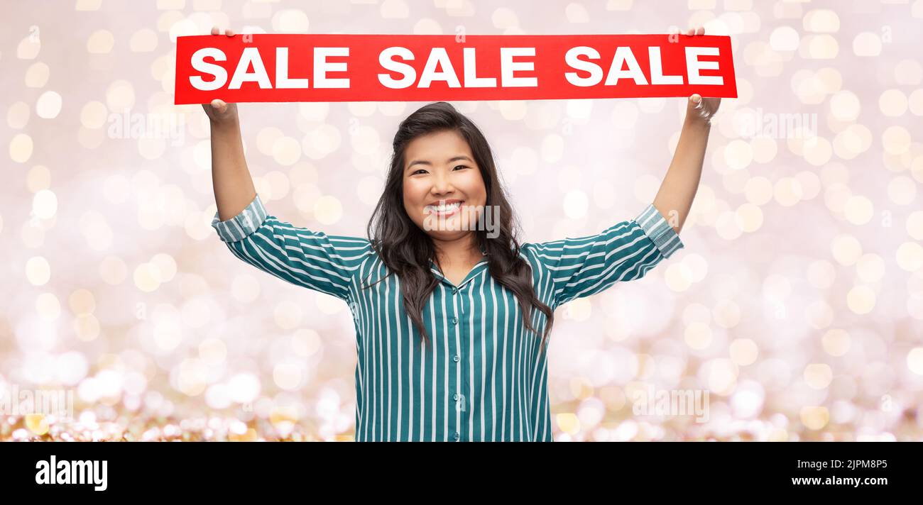 happy smiling young asian woman with sale banner Stock Photo - Alamy