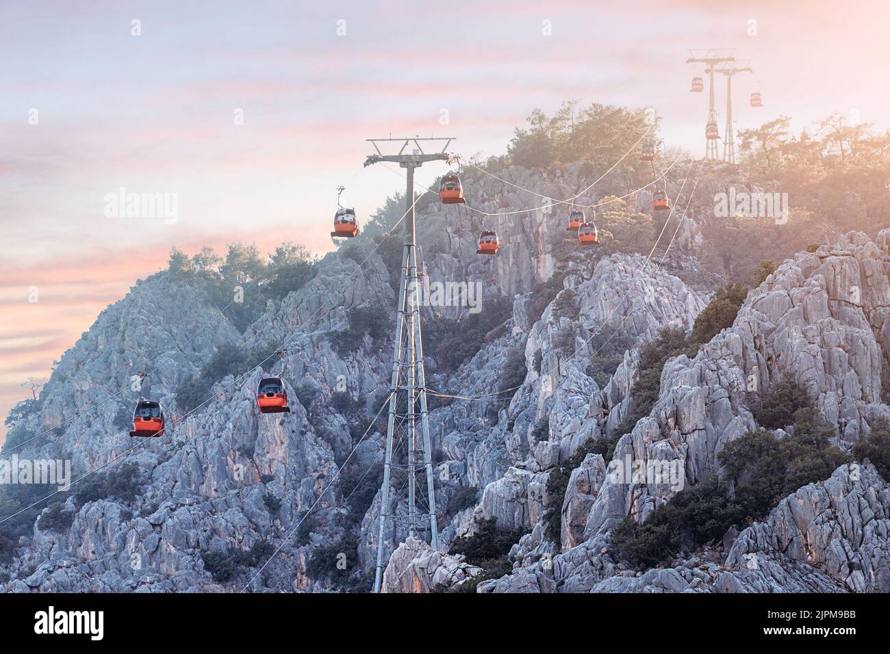 Cable car or ropeway carries tourists in closed gondolas to a viewing ...