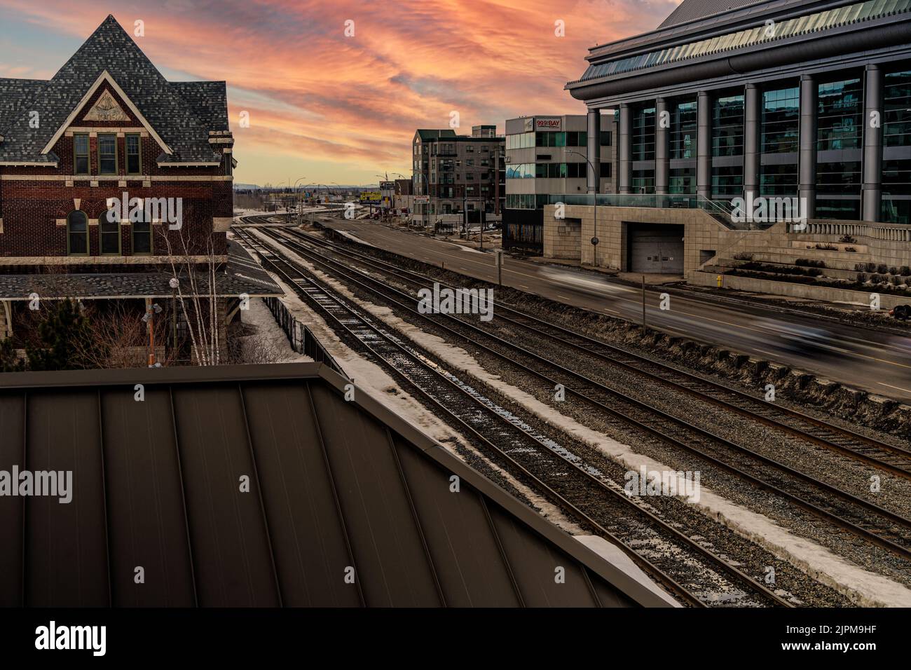 A beautiful sunset over the empty railroad and platform between ...