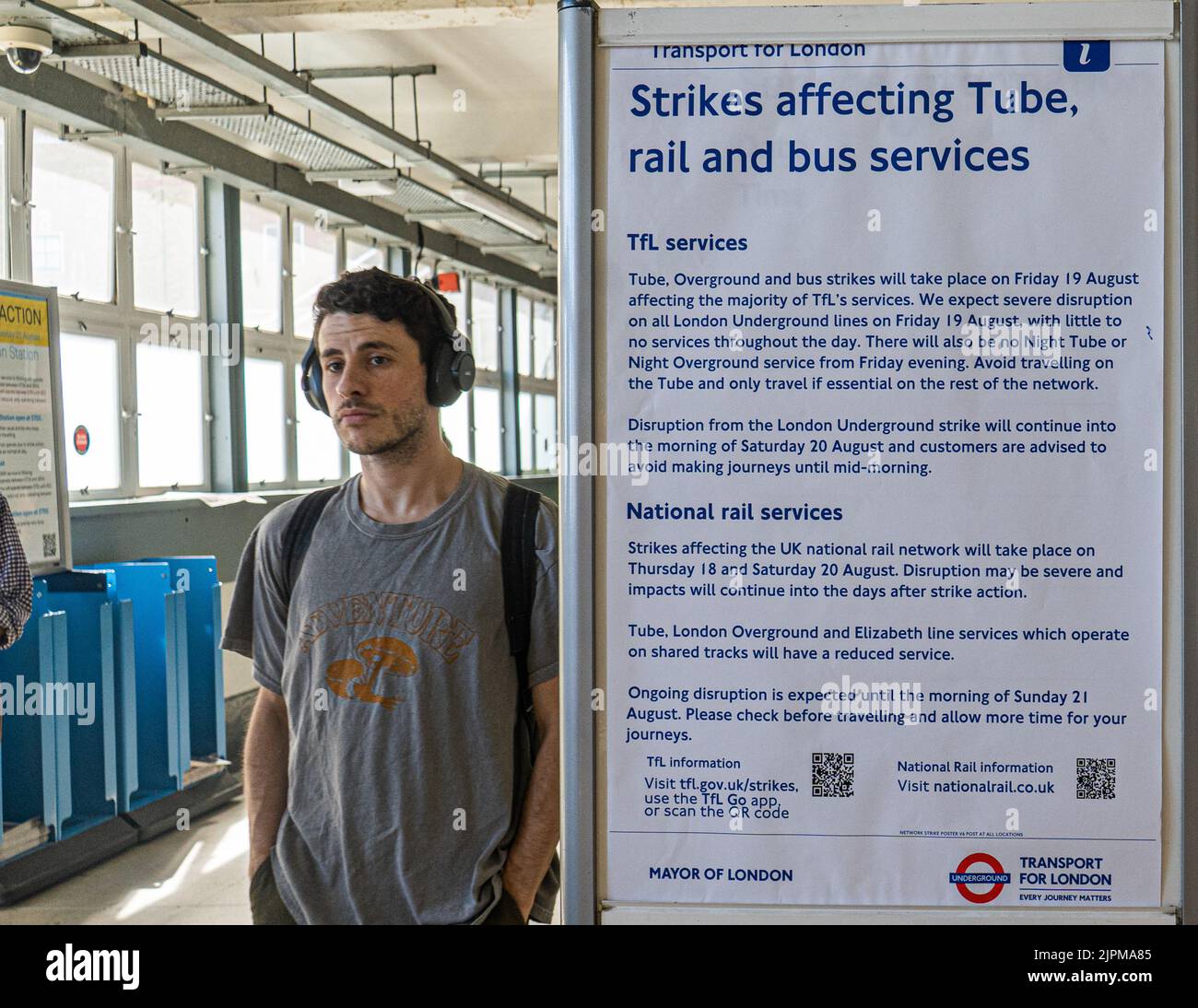 Wimbledon London, UK. 19 August 2022 . A commuter walks past an TFL ...