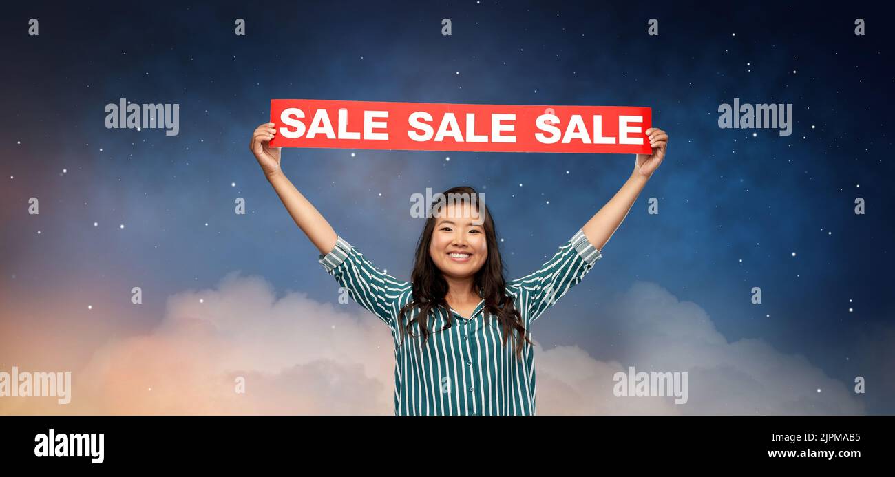 happy smiling young asian woman with sale banner Stock Photo - Alamy