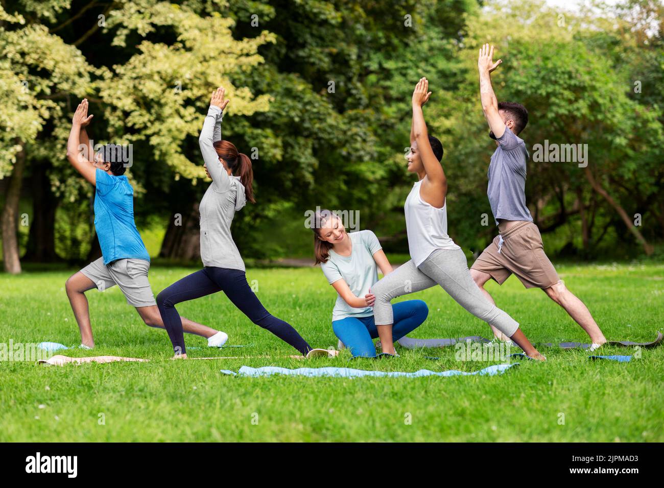 Group people doing yoga warrior hi-res stock photography and images - Alamy