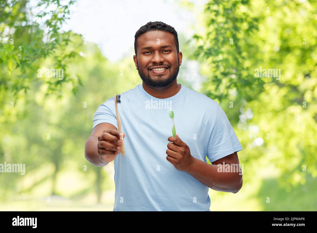 african man with wooden and plastic toothbrushes Stock Photo - Alamy
