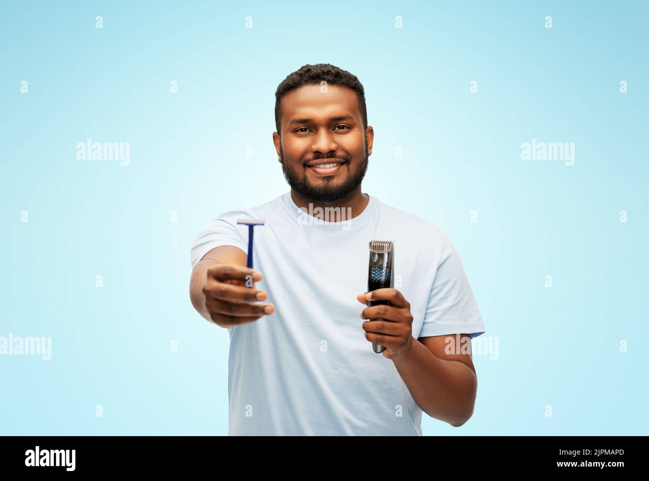 smiling african man with razor blade and trimmer Stock Photo - Alamy