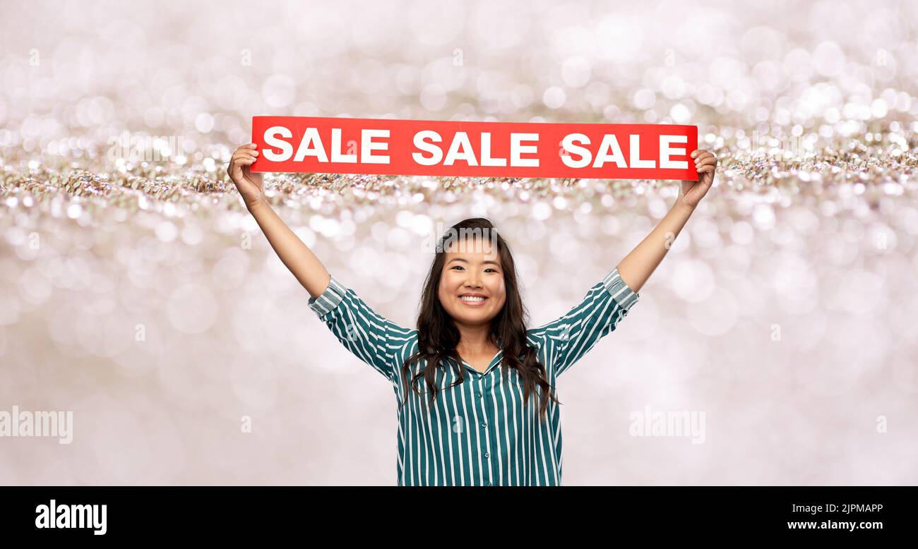 happy smiling young asian woman with sale banner Stock Photo - Alamy