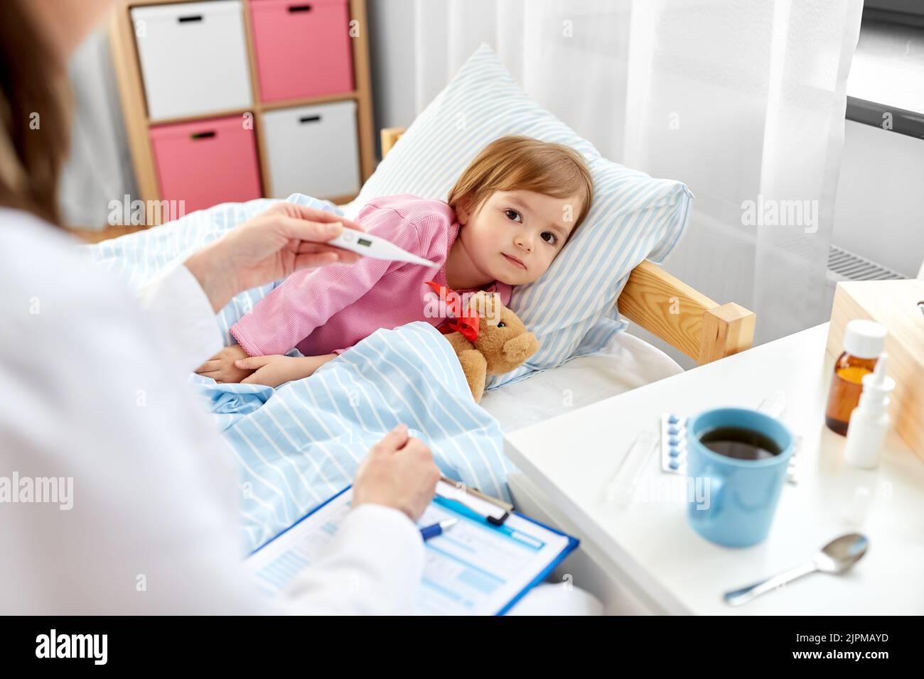 doctor measuring sick girl's temperature Stock Photo - Alamy