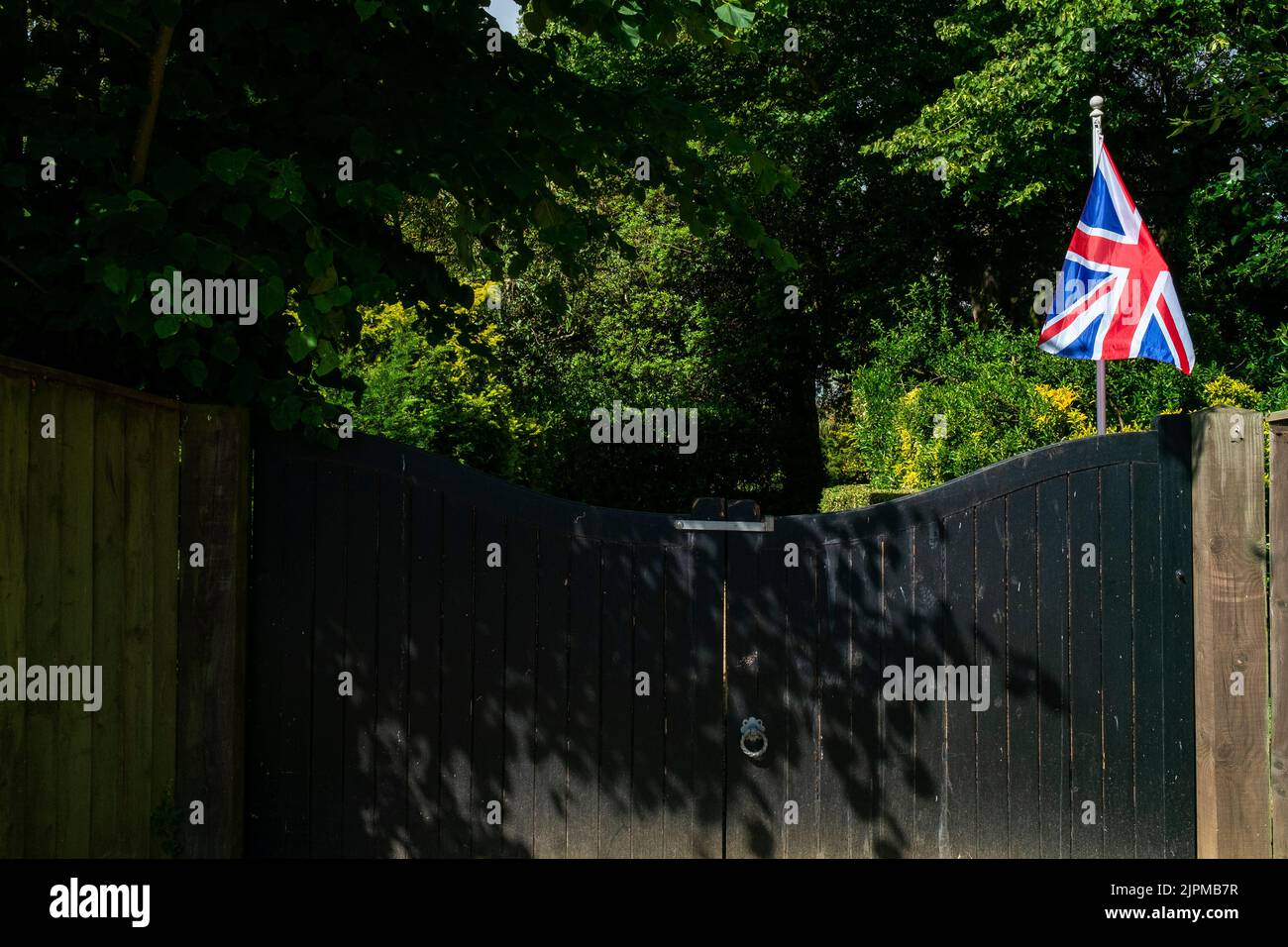 Plastic Union Jack flag outside a gated property Stock Photo - Alamy
