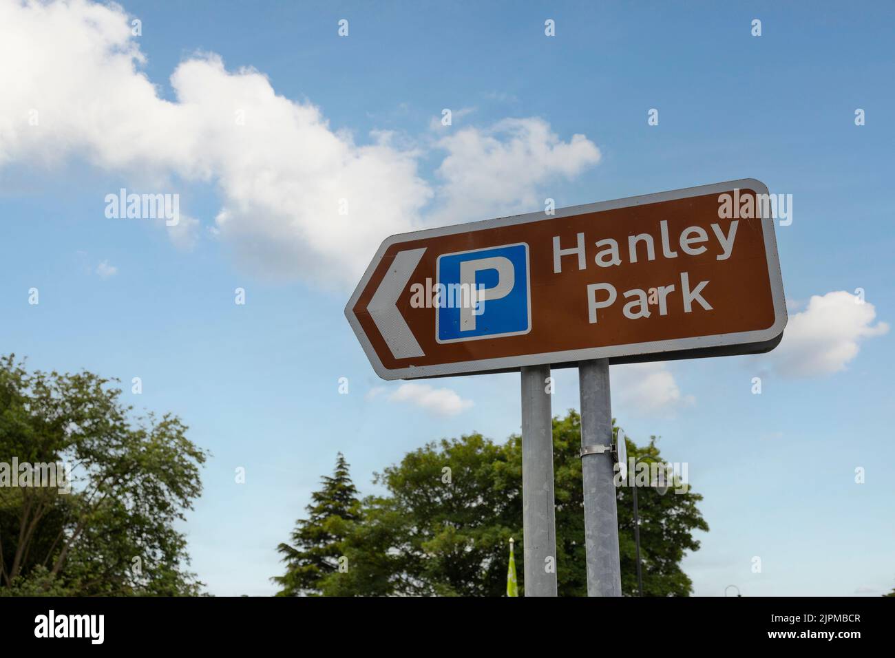 brown hanley park sign with blue parking sign blue sky Stock Photo - Alamy