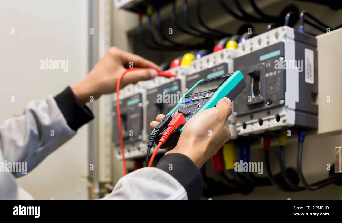 Electrical engineer checking the operation of electrical control ...