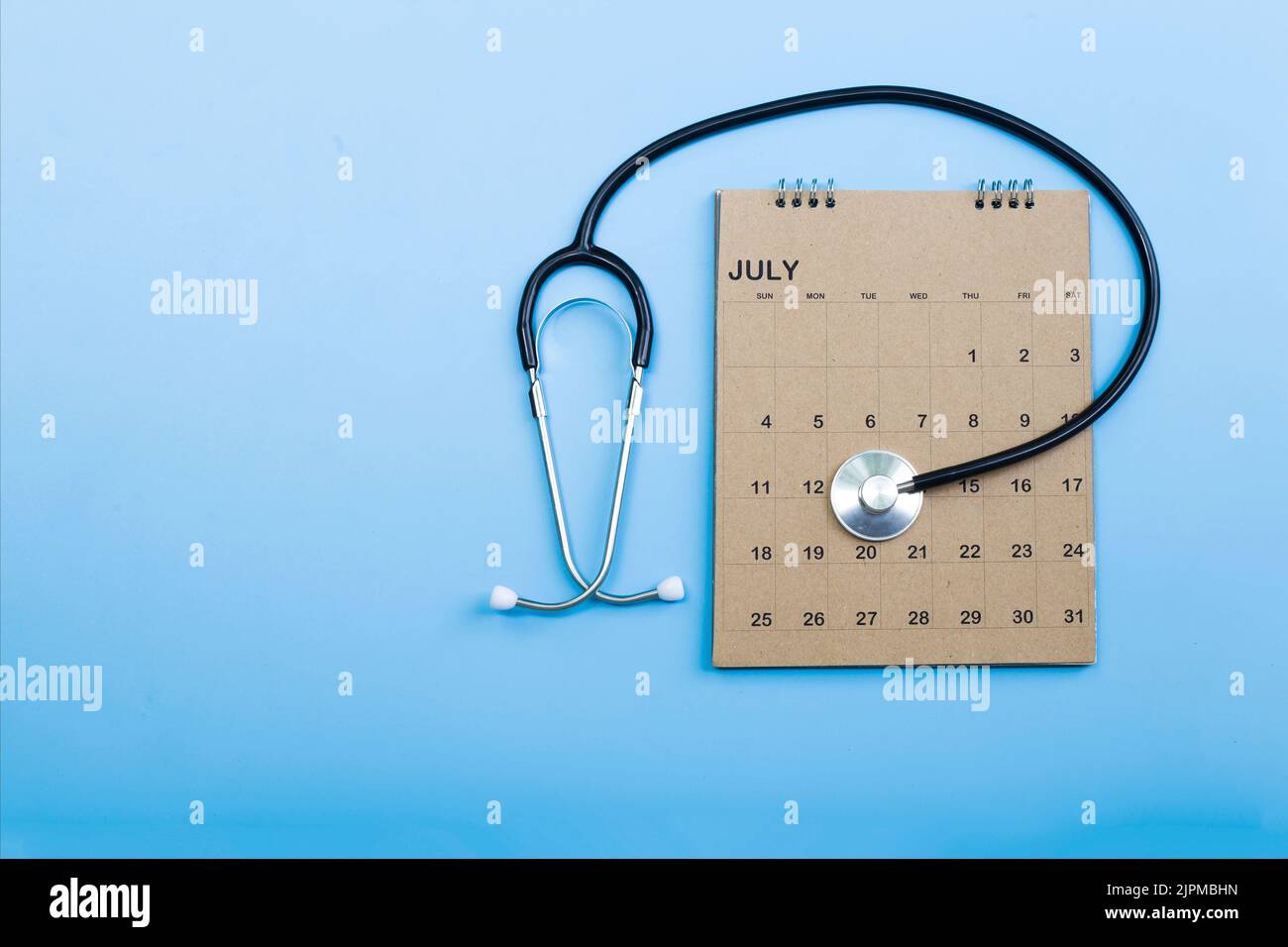 Calendar, stethoscope, on a blue background, health care concept Stock ...