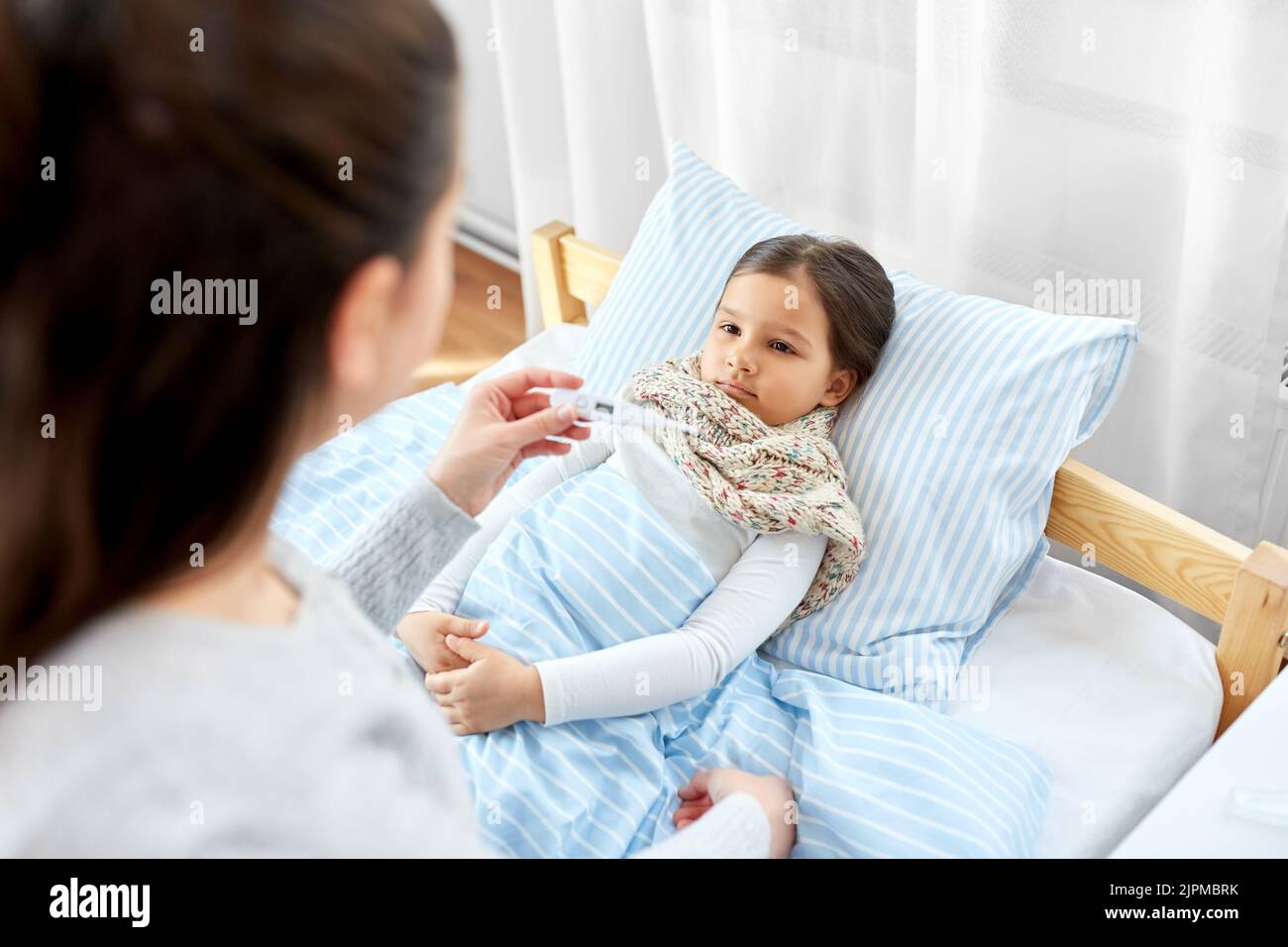 mother measuring temperature of sick daughter Stock Photo - Alamy