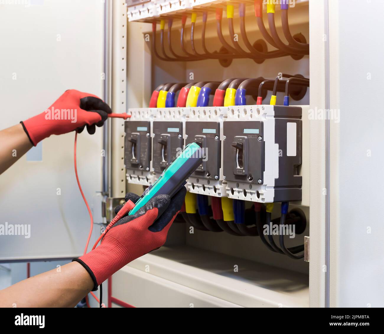 Electrical engineer checking the operation of electrical control ...