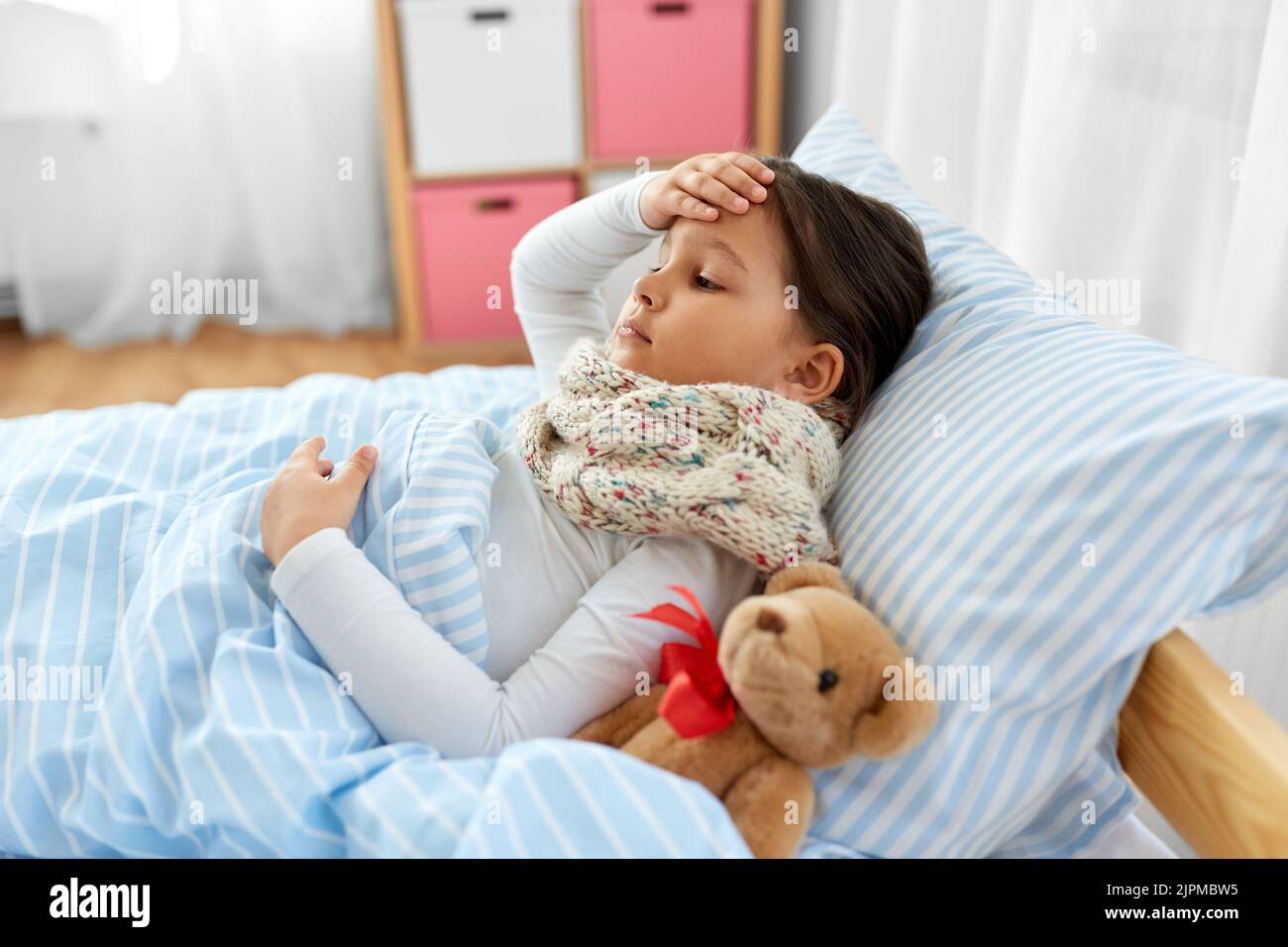 sick girl lying in bed at home Stock Photo - Alamy