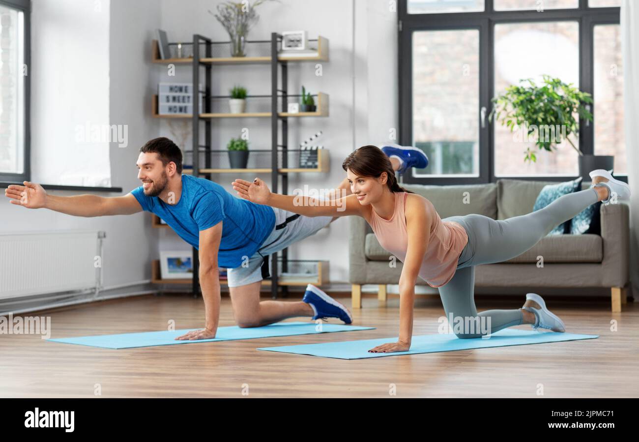 happy couple exercising at home Stock Photo - Alamy